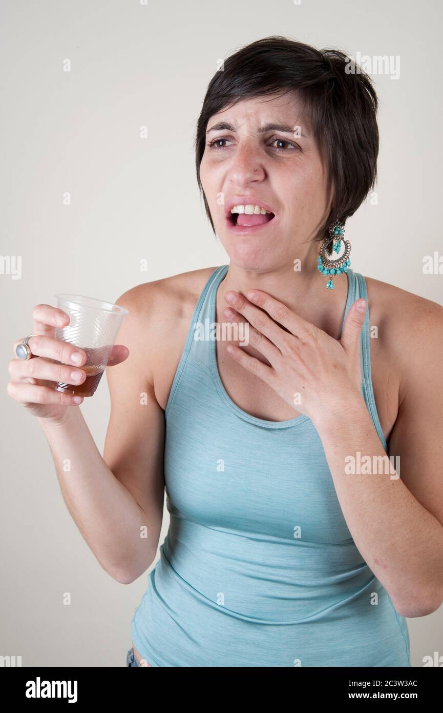Studio shot of a female model in her 20s looking disgusted on white ...