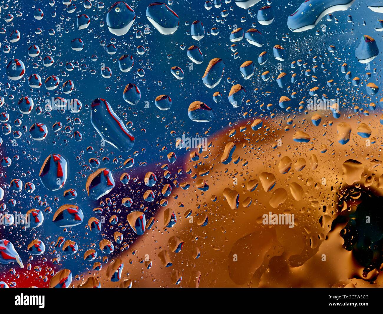 Colourful water drops, droplets, on a hard surface showing abstraction ...
