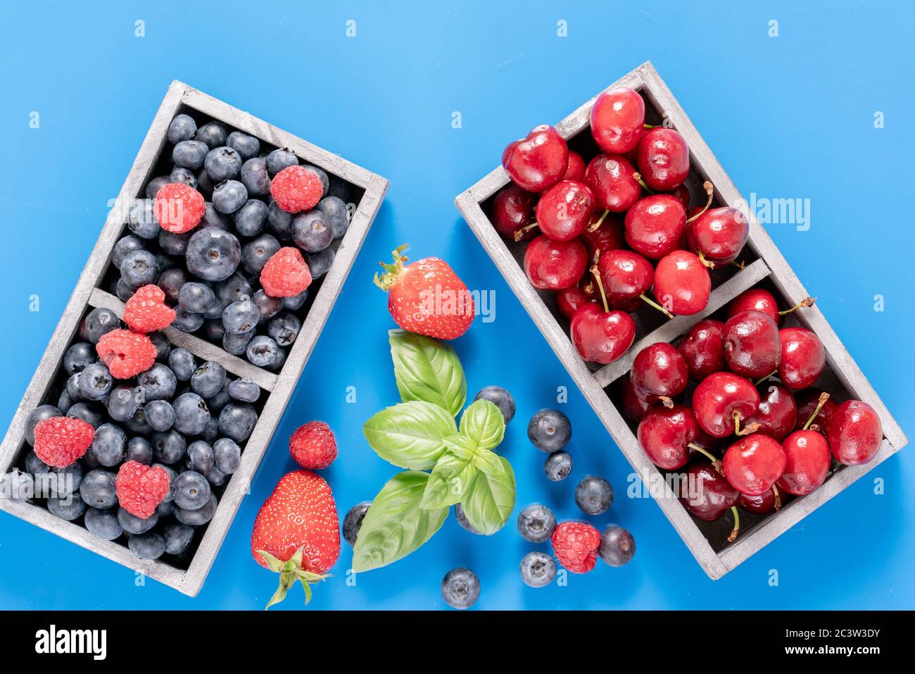 blueberries and cherries in wooden boxes Stock Photo - Alamy
