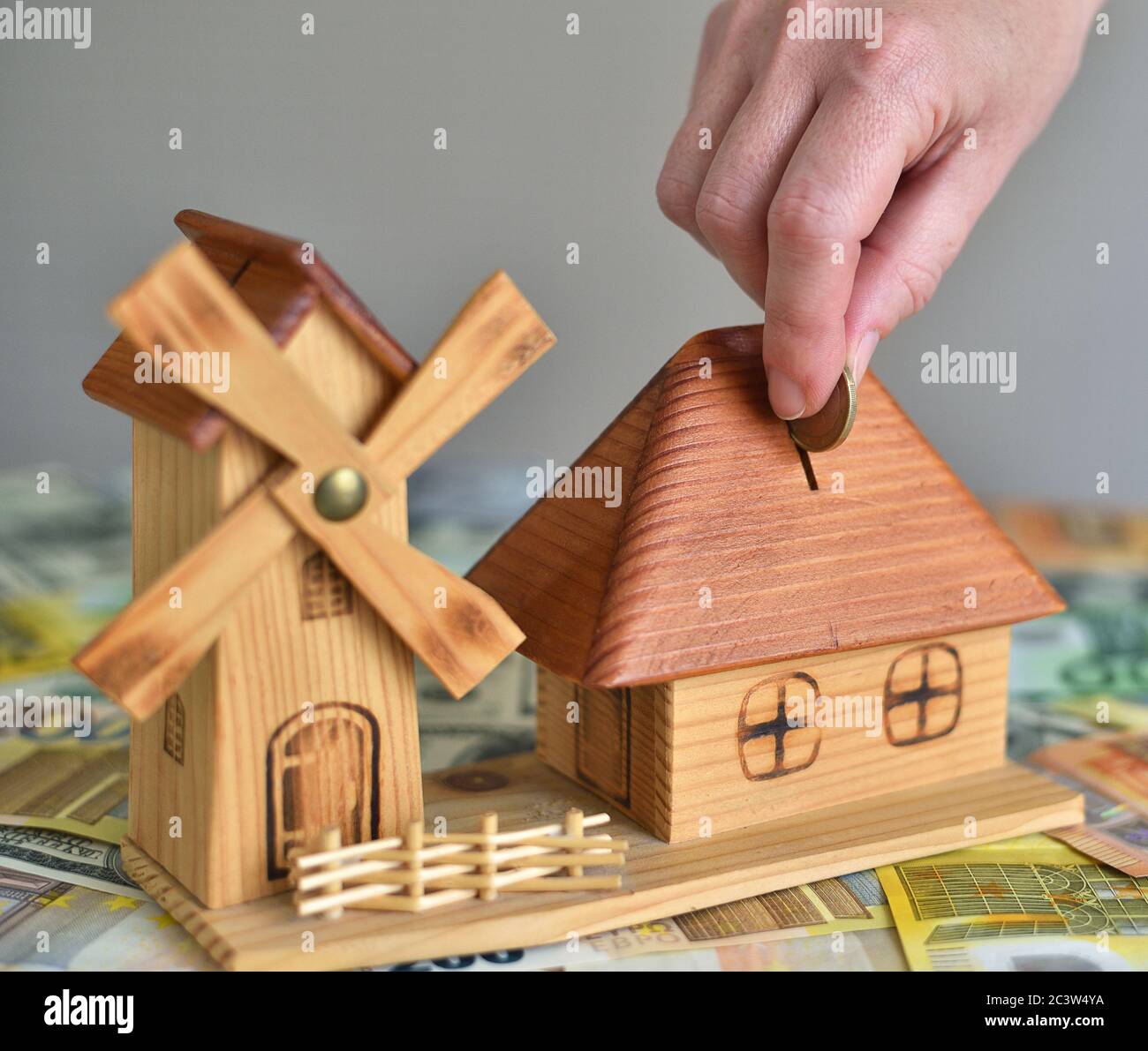 Hand Putting Coin In money box Stock Photo - Alamy