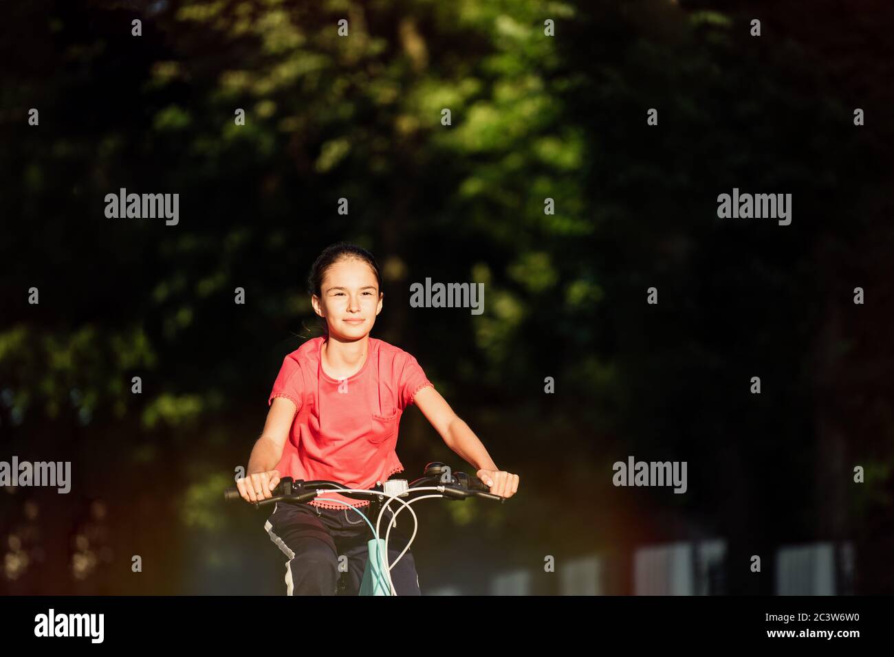 Girl Kid Riding Bike in Summer in City at Beautiful Sunset Stock Photo ...