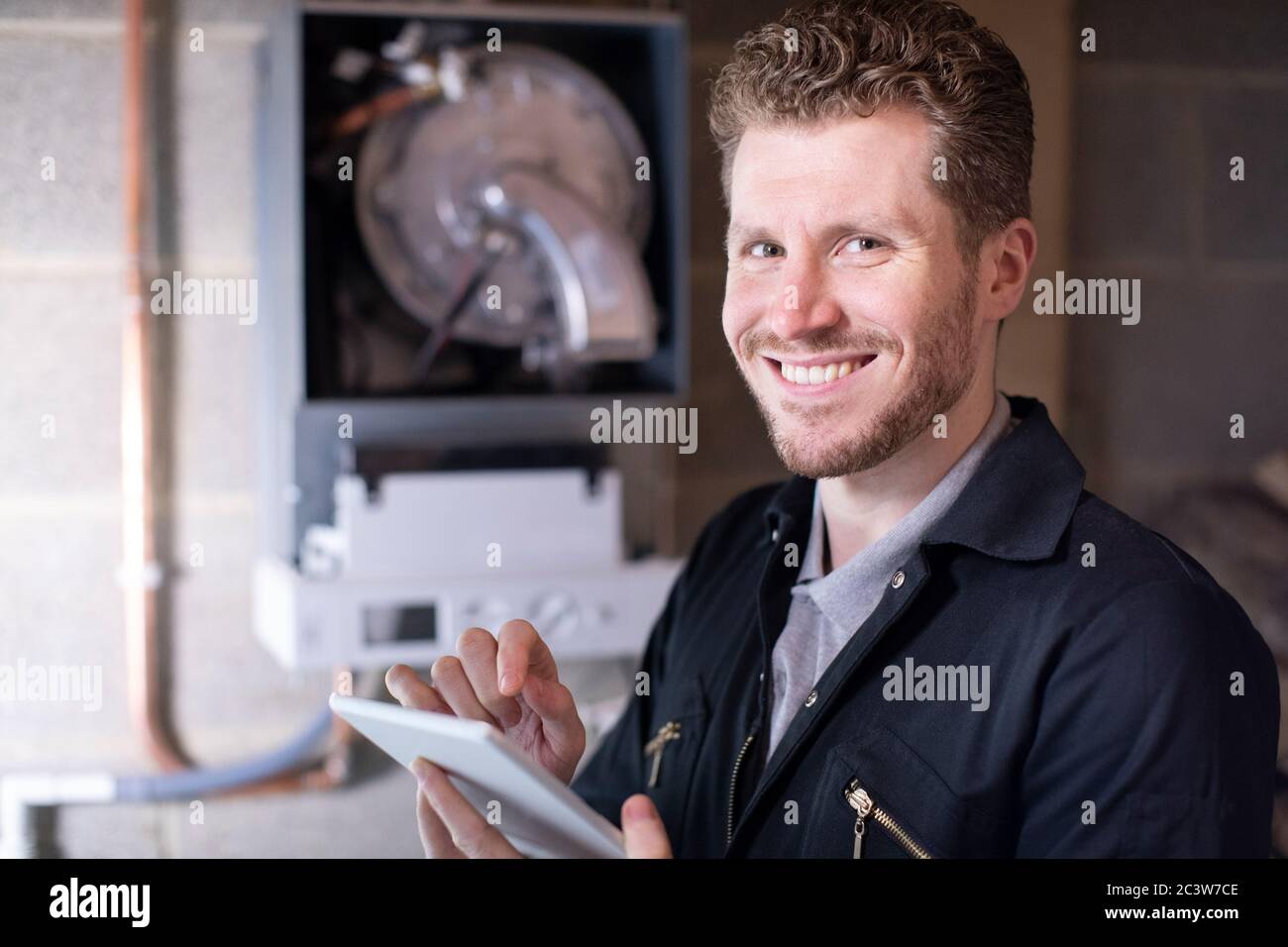 Portrait Of Male Heating Engineer Servicing Central Heating Boiler ...