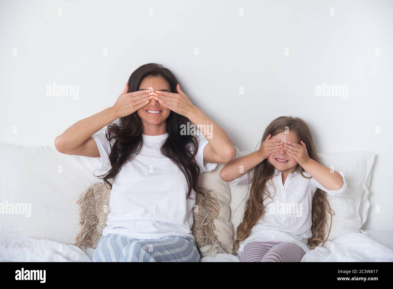 Happy loving family lying relaxing and enjoying in bedroom together ...