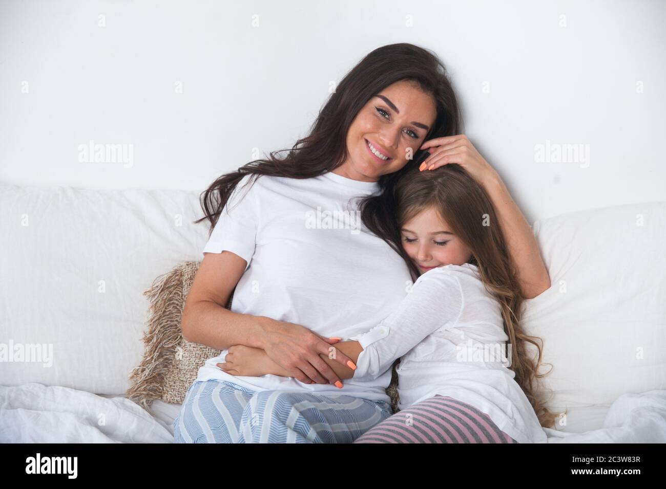 Happy loving family lying relaxing and enjoying in bedroom together ...