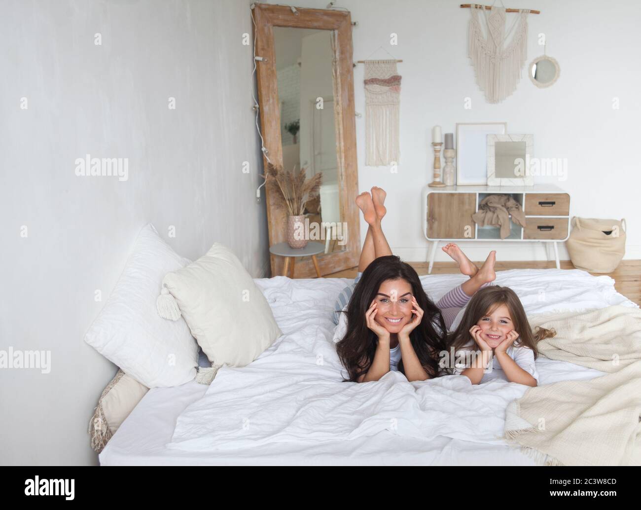 Happy loving family lying relaxing and enjoying in bedroom together ...