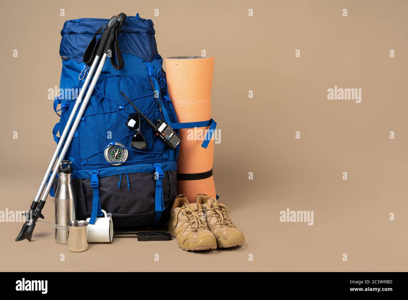 Blue backpack and hiking boots. Mountain gear close up Stock Photo - Alamy