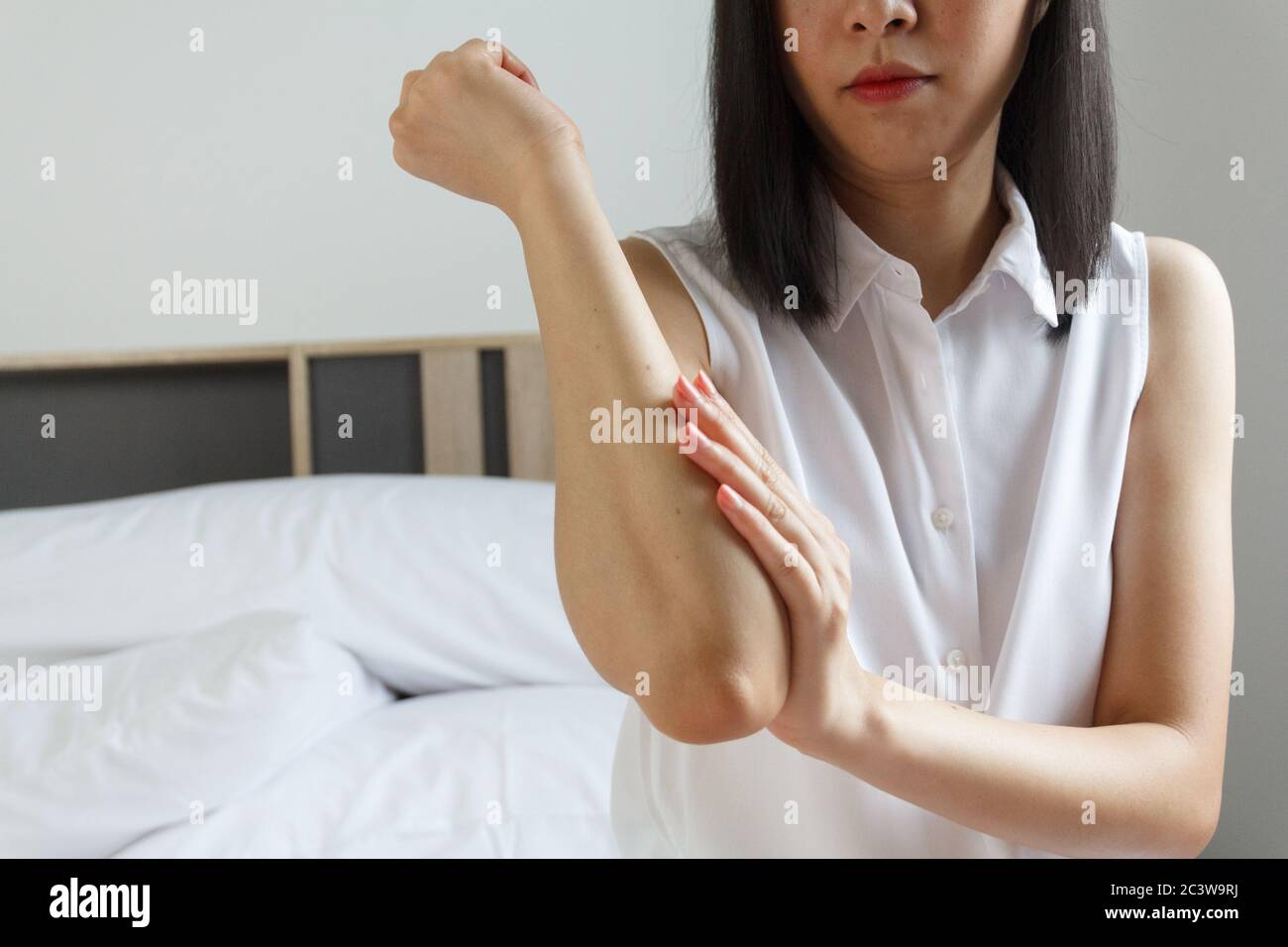 The Woman having pain in injured elbow at home . Health care concept ...
