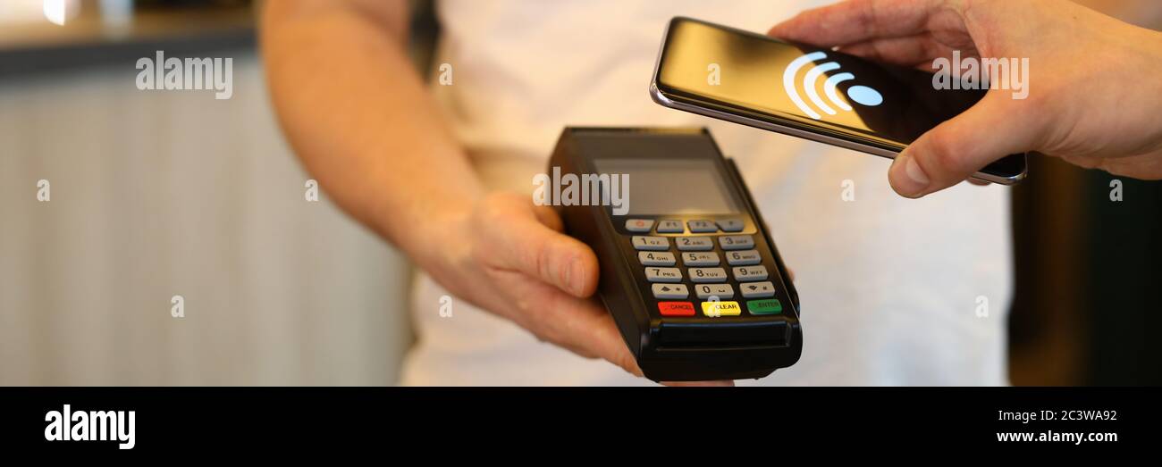 Client paying bill using cellphone Stock Photo - Alamy
