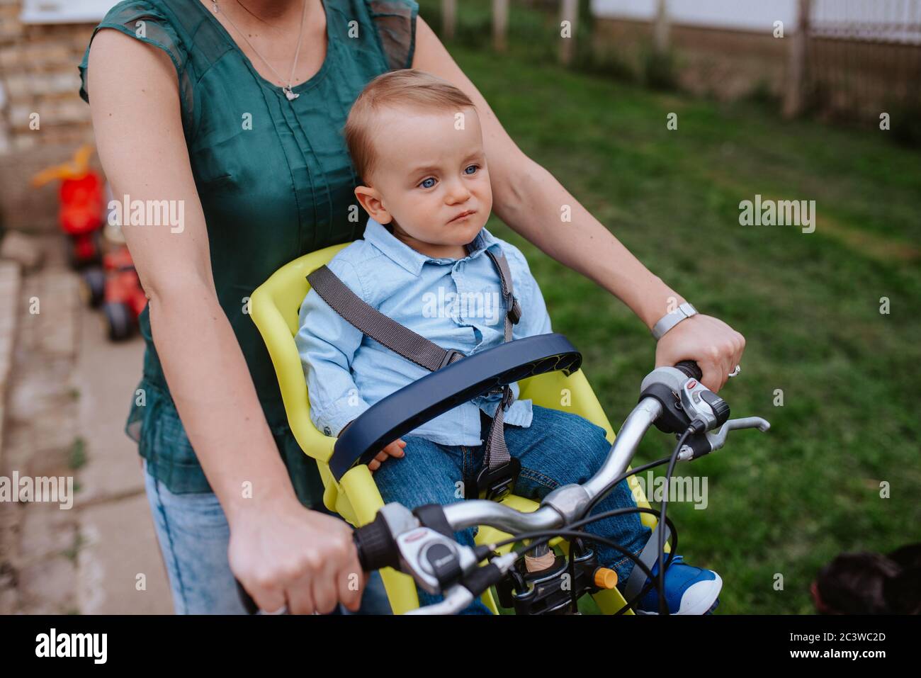 A caucasian mother rides a beautiful child on a bicycle Stock Photo - Alamy