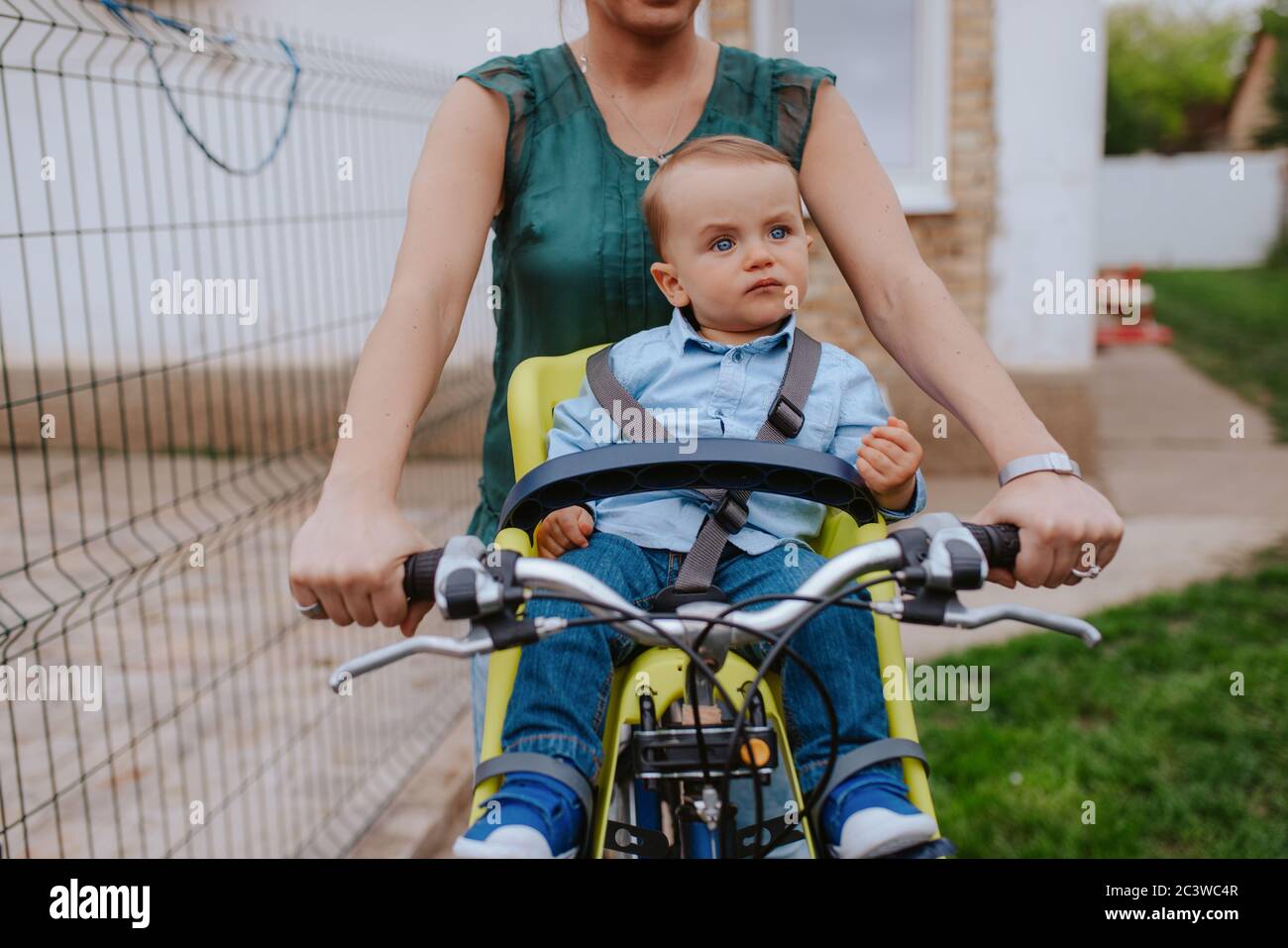 A caucasian mother rides a beautiful child on a bicycle Stock Photo - Alamy