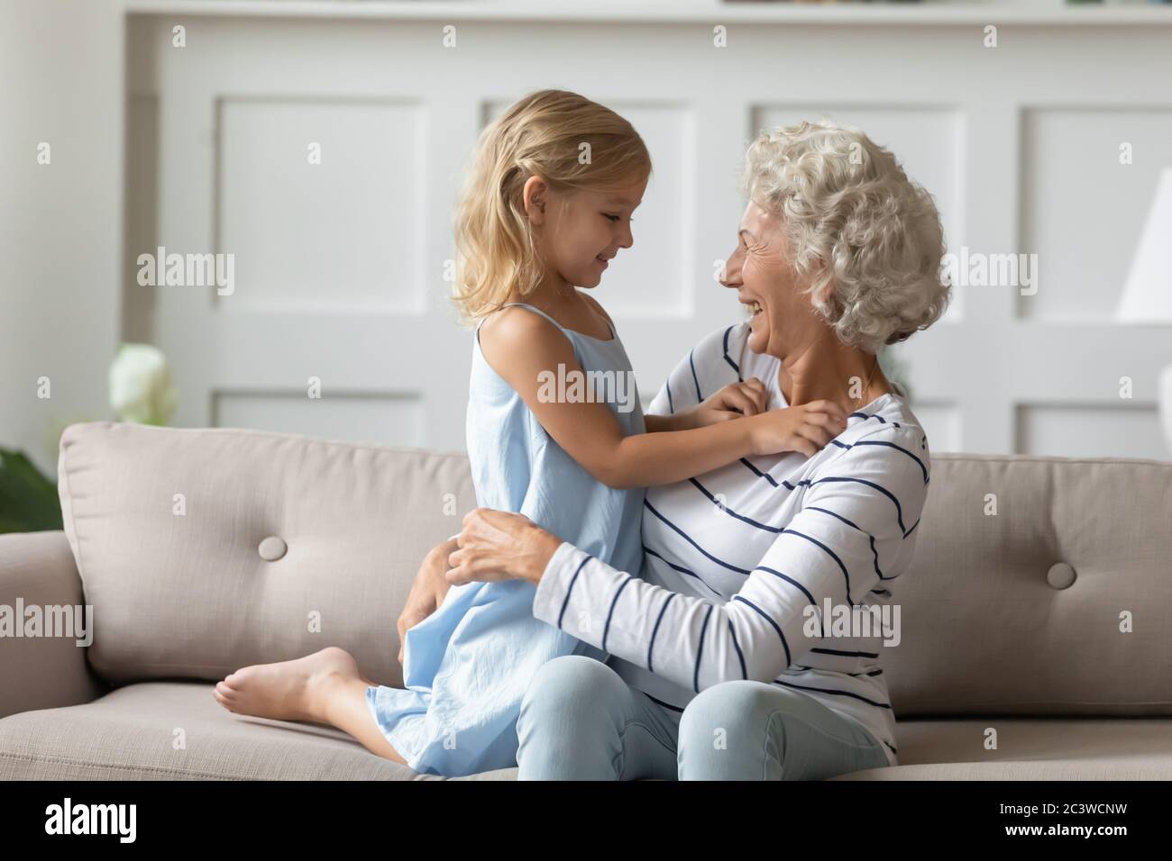 Older grandmother spend pleasant time with pretty little granddaughter ...