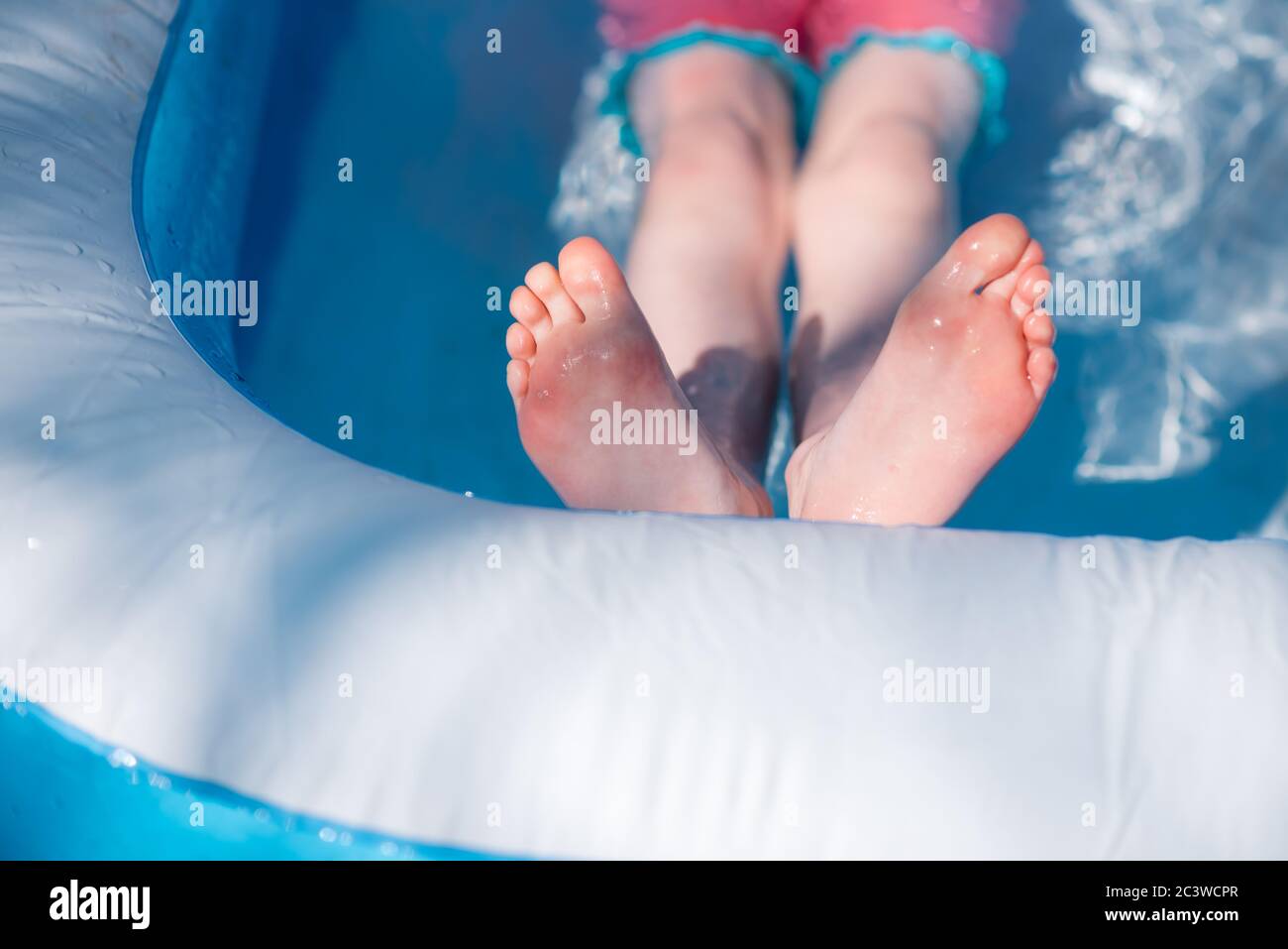 Little girl feet up hi-res stock photography and images - Alamy