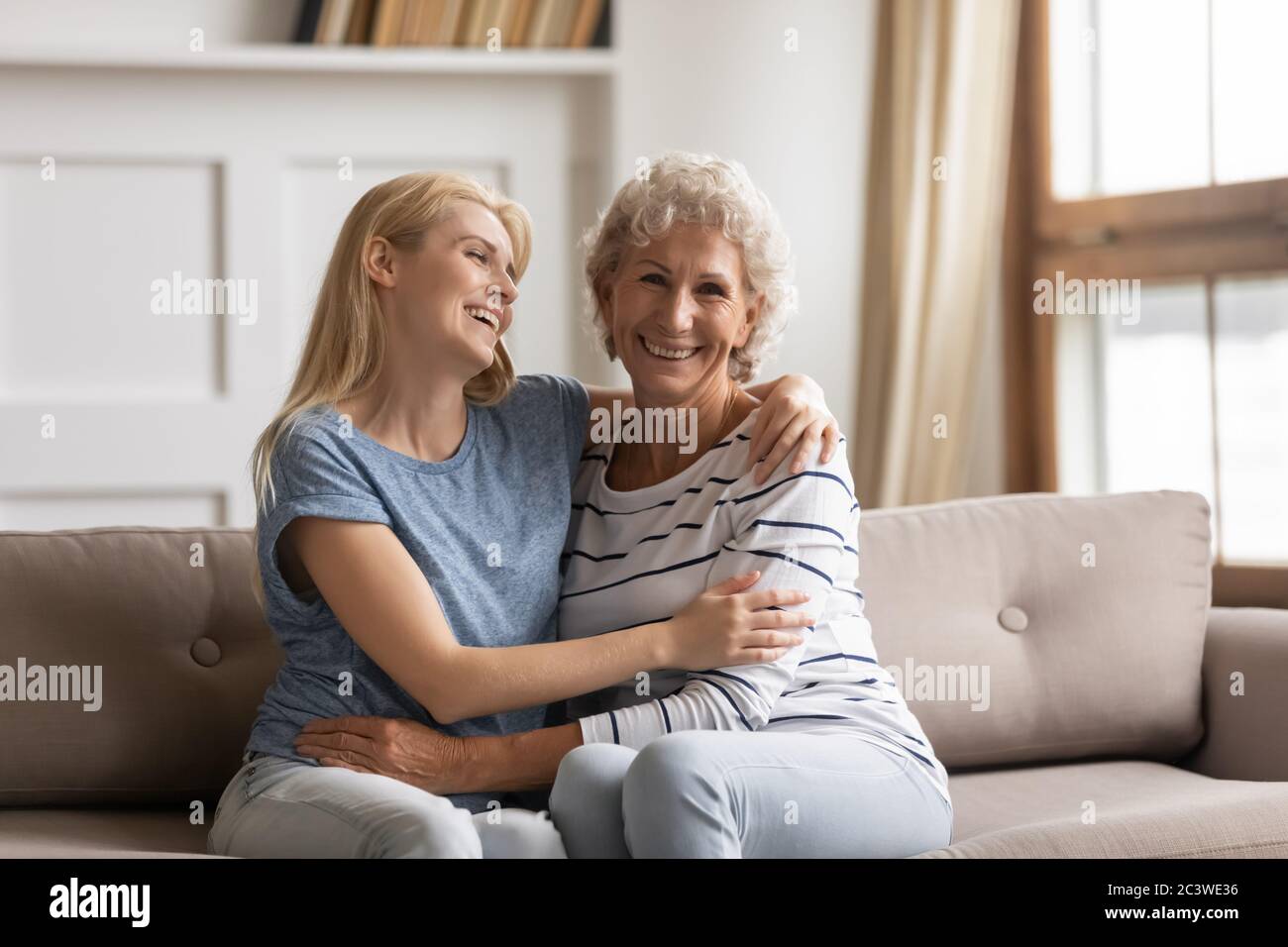 Two older women hugging hi-res stock photography and images - Alamy