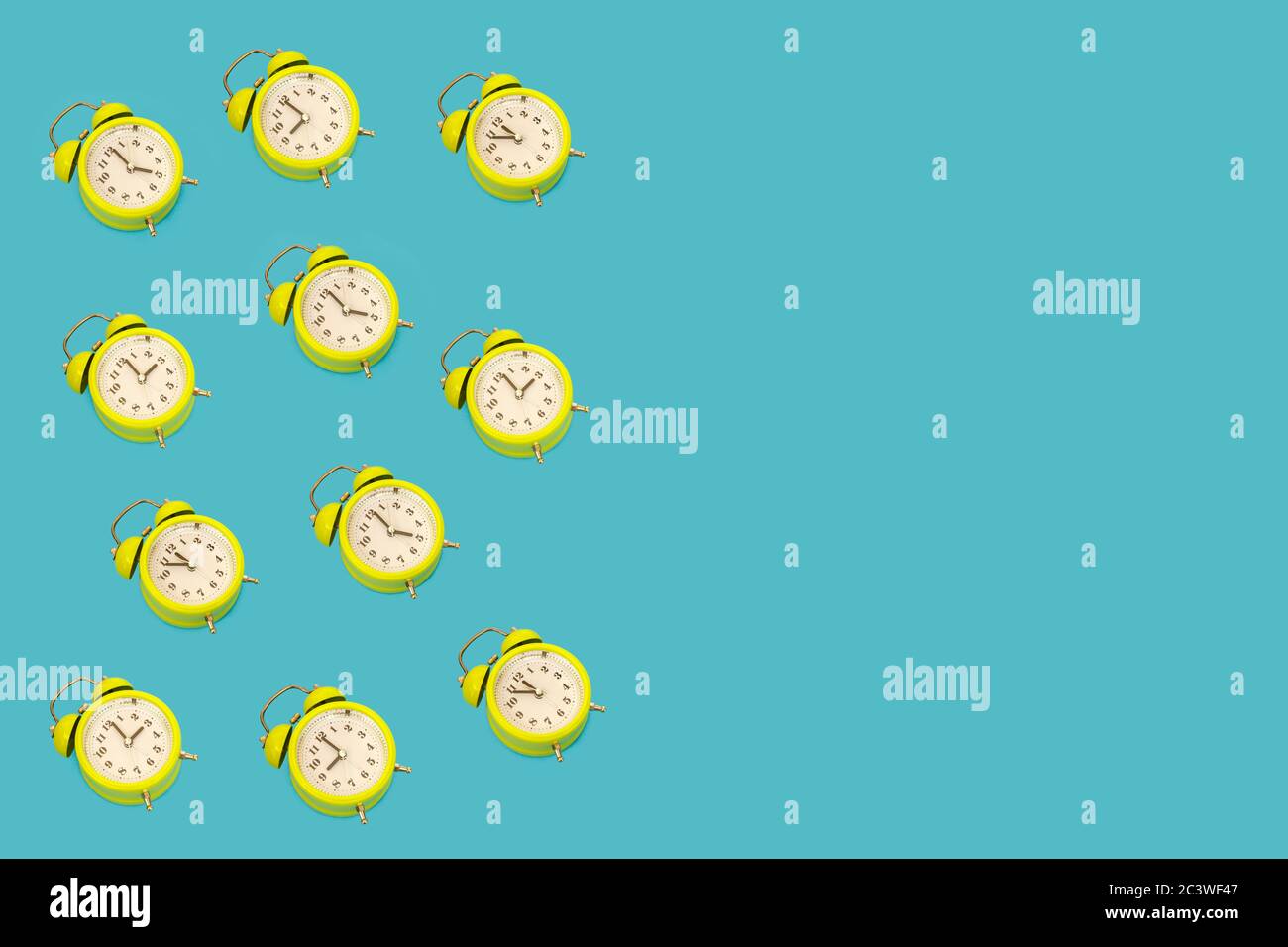 A lot of classic style alarm clock isolated on light blue background ...