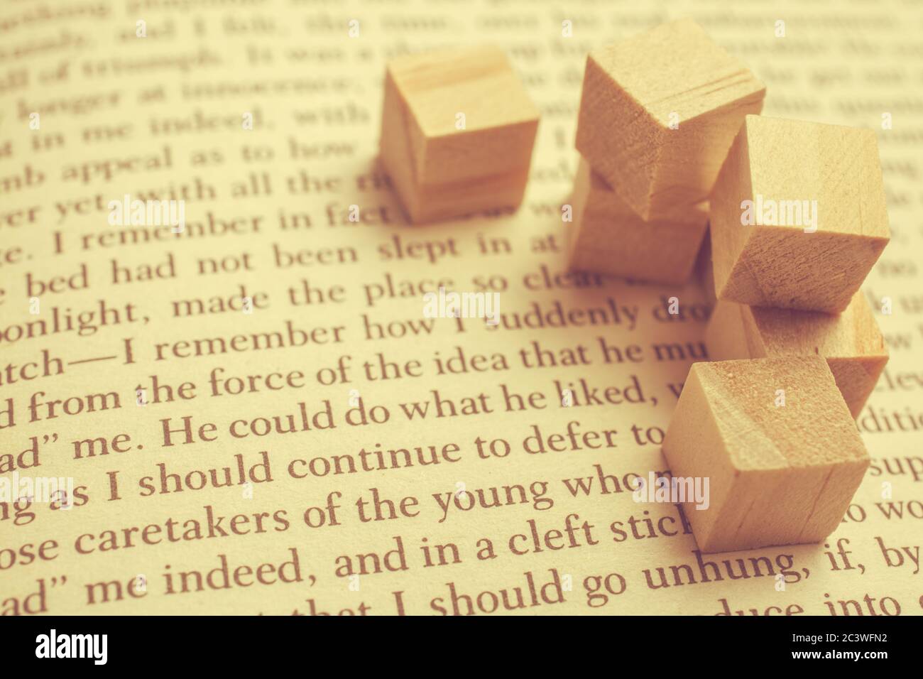 wooden toy cubes placed on a book page in English Stock Photo - Alamy