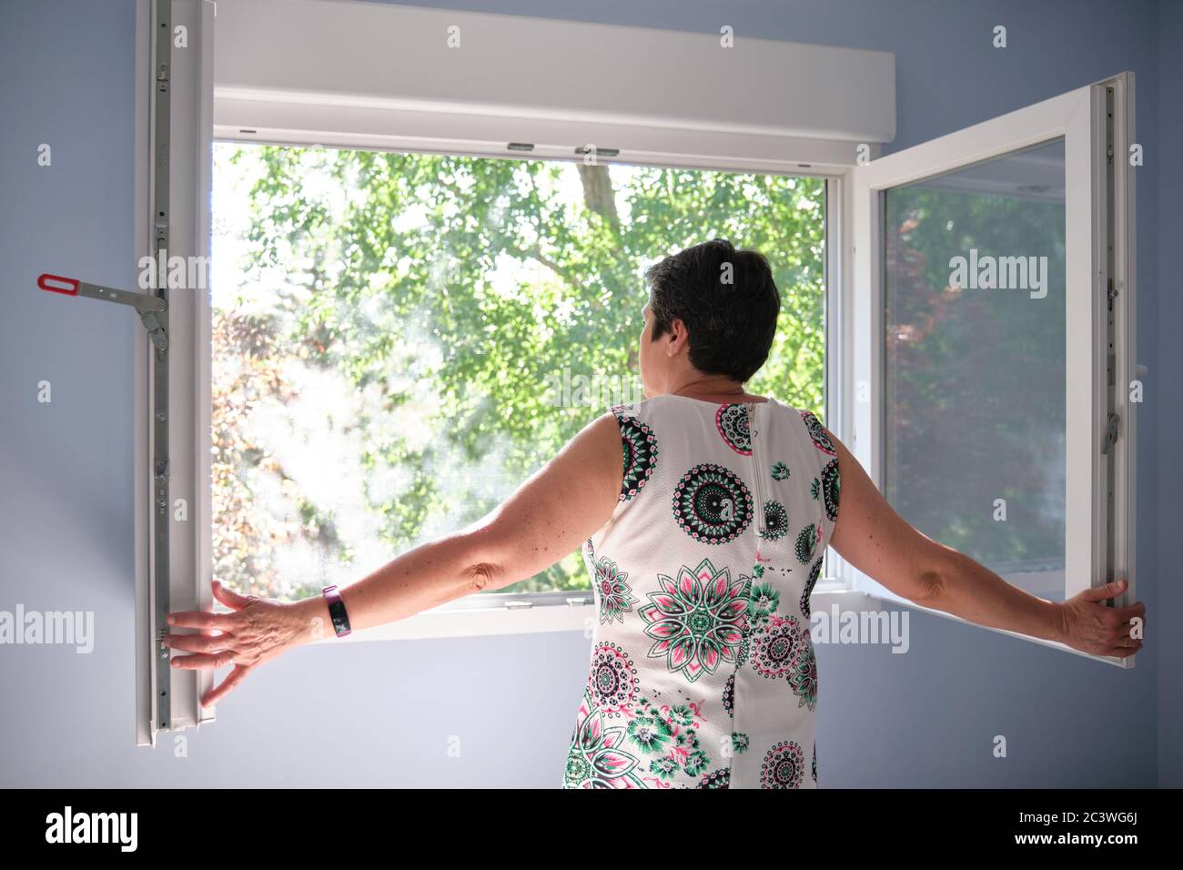 Woman opening the window to take a breath. Quarantine concept Stock ...