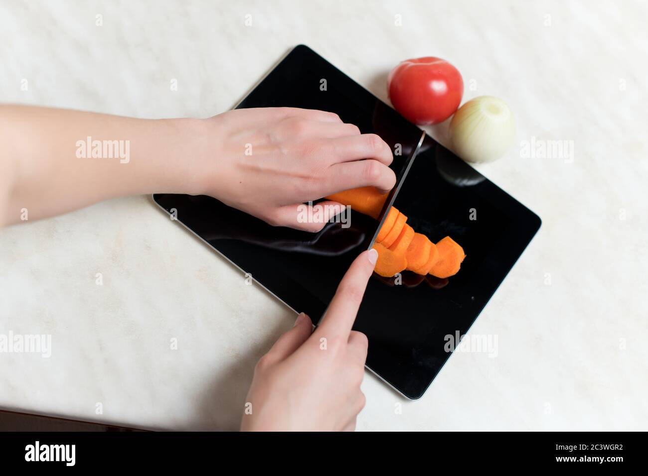 An old tablet serves as a cutting board for cutting vegetables Stock ...