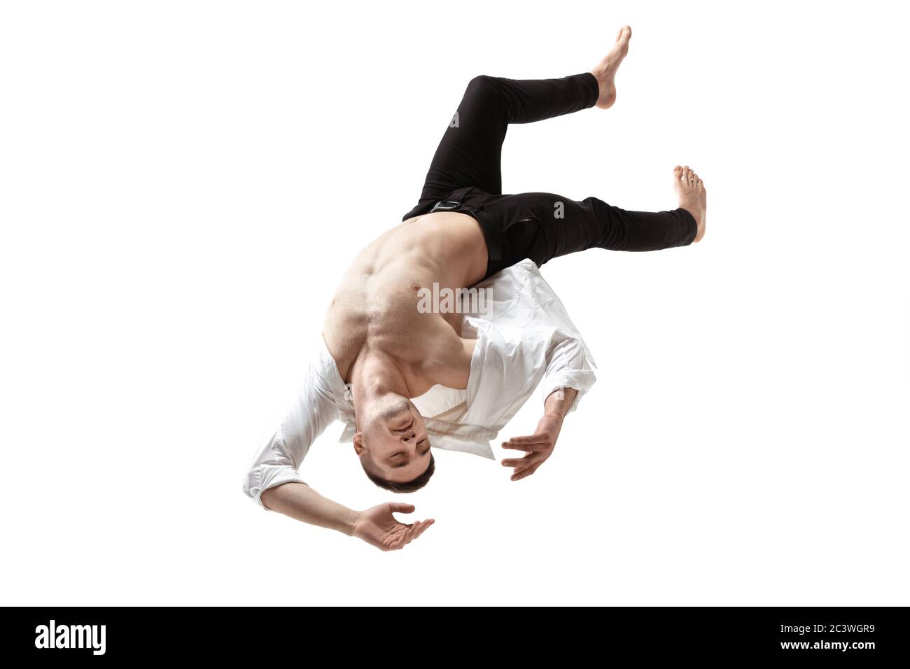 Mid-air beauty cought in moment. Full length shot of young man hovering ...