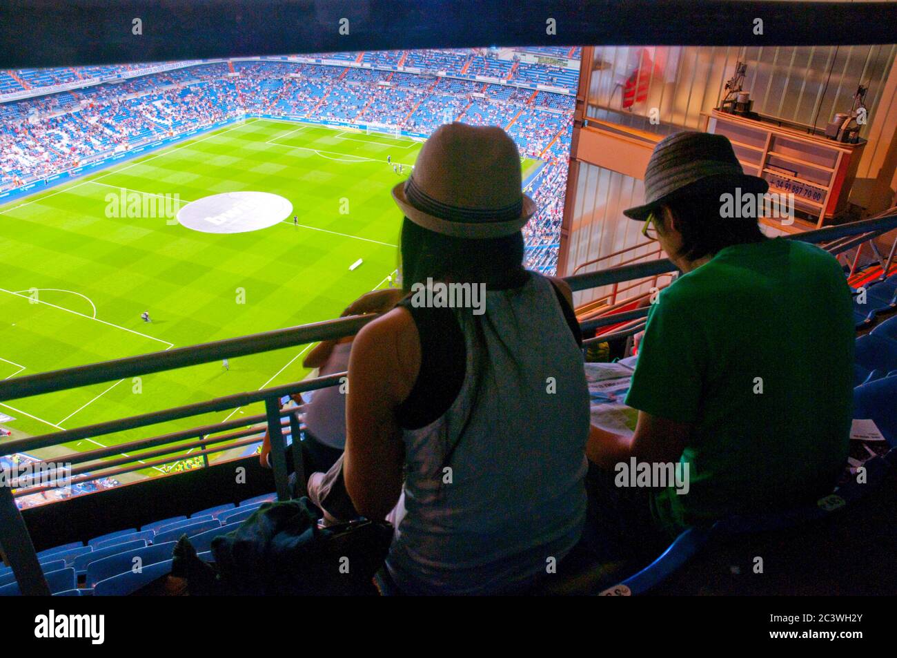 Two tourists watching football match, Santiago Bernabeu Stadium, Madrid ...