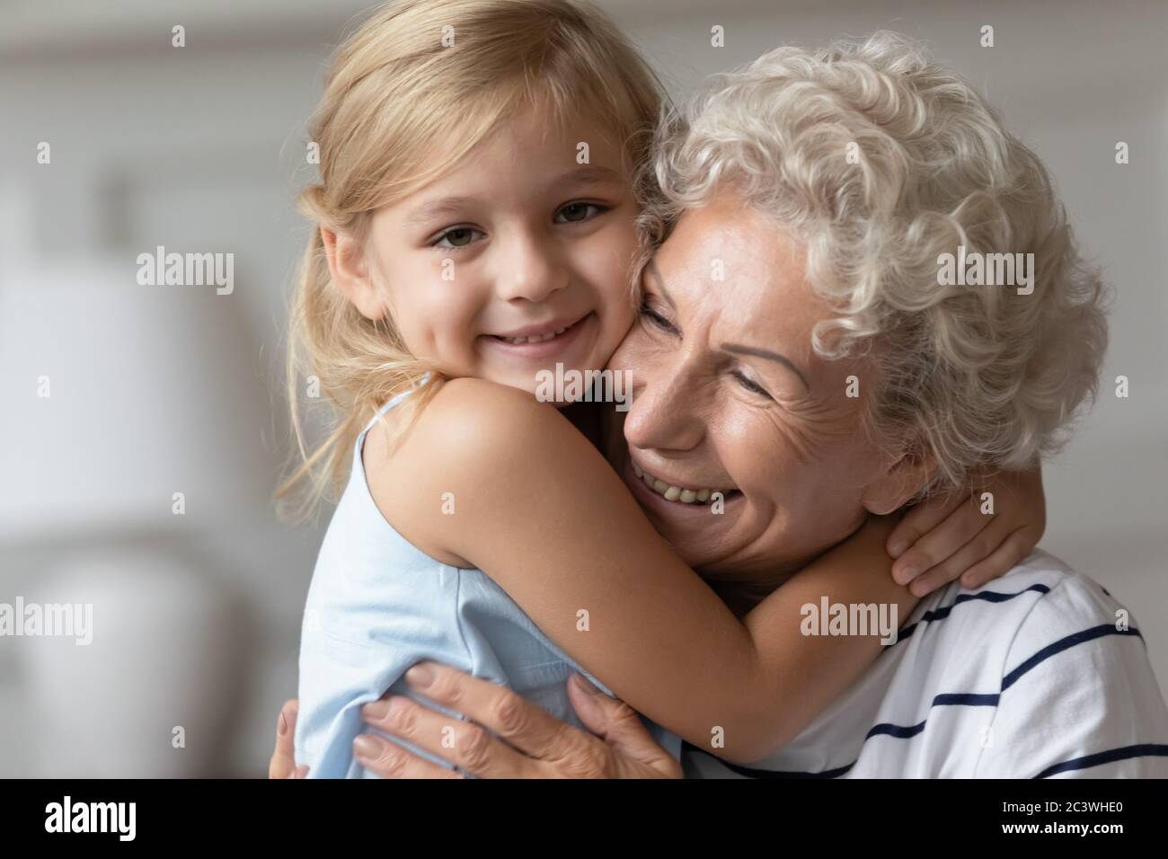 Grandmother hugging grandchild hi-res stock photography and images - Alamy