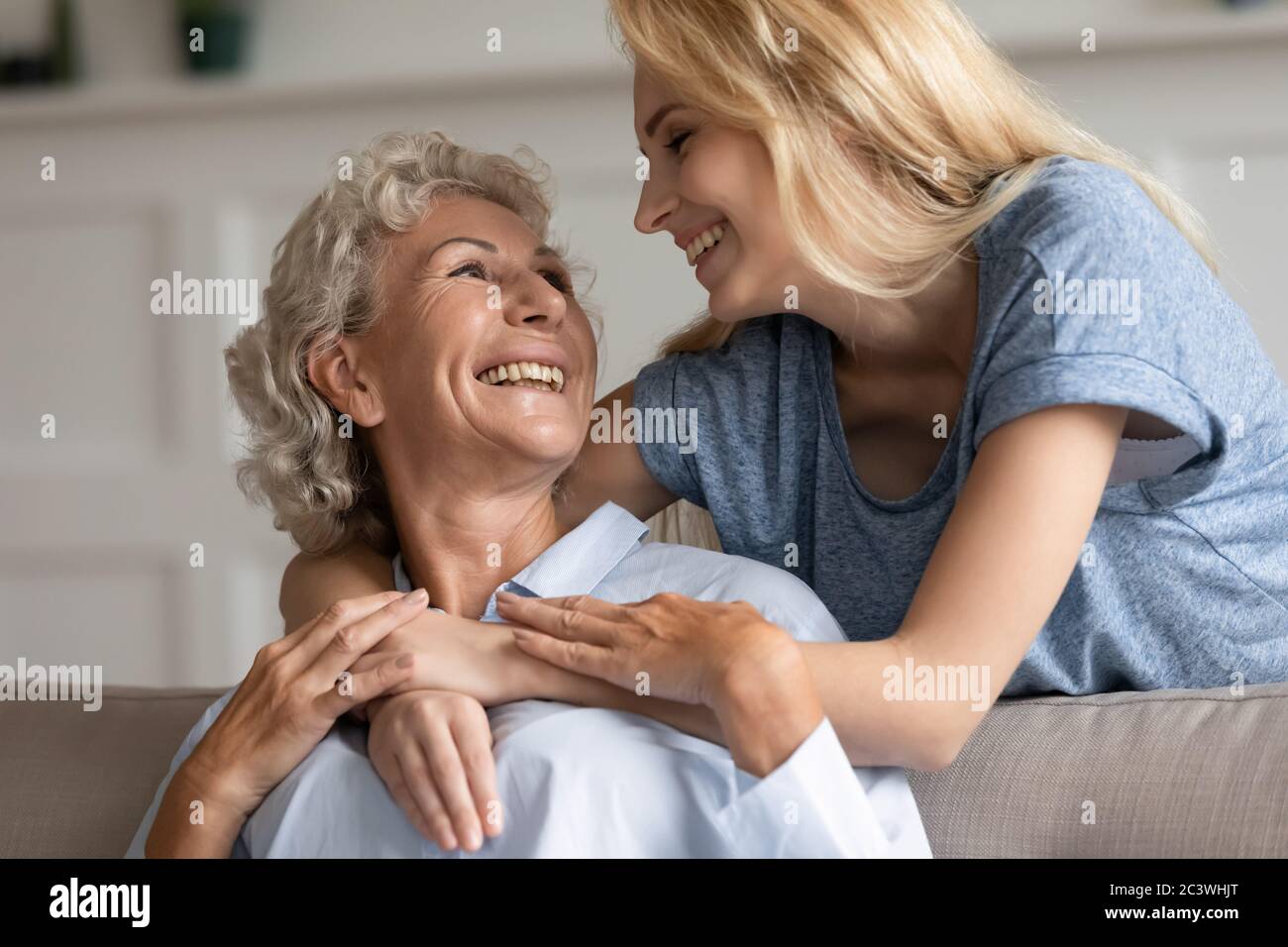 Grown up daughter hugging elderly mother feeling love showing care ...