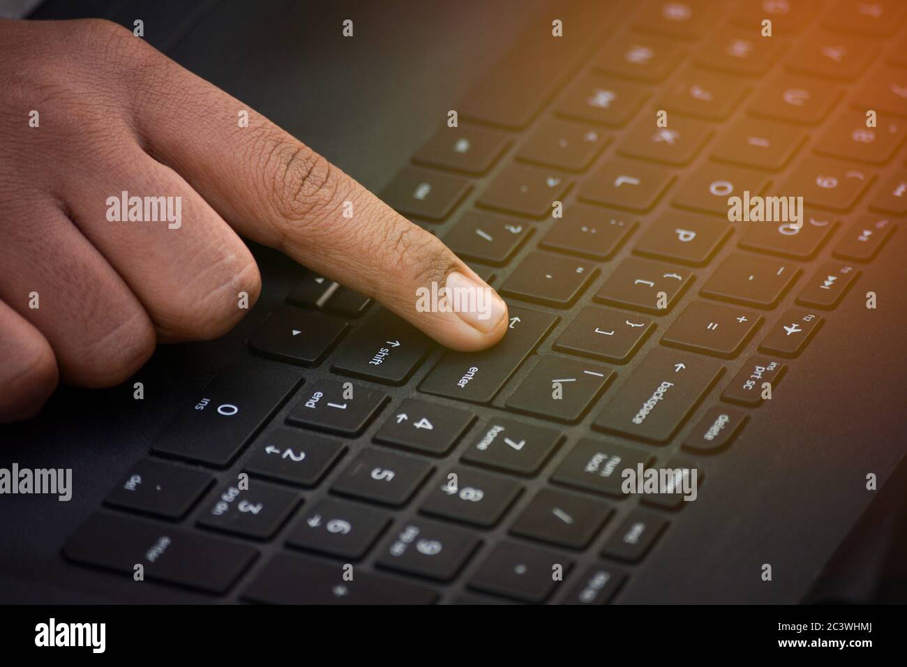 Index finger presses the enter key on the laptop keyboard Stock Photo ...