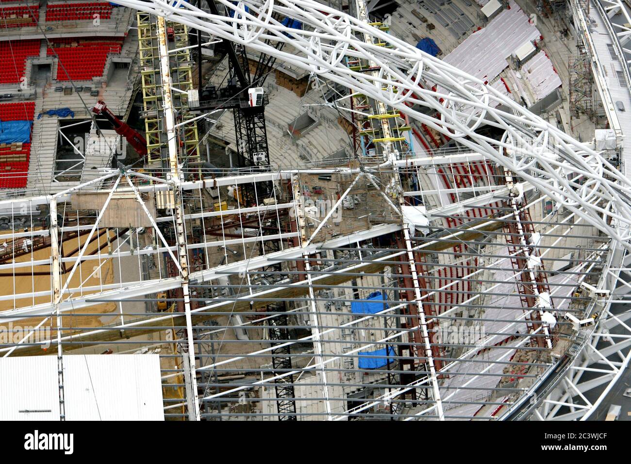 Rebuilding Wembley Stadium. A girder falls from the roof structure and ...