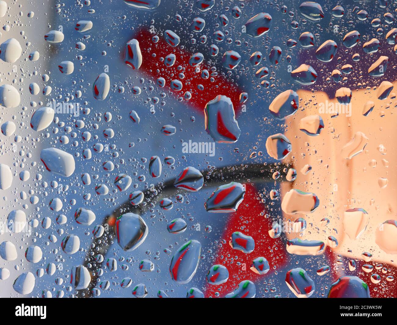 Colourful water drops, droplets, on a hard surface showing abstraction ...