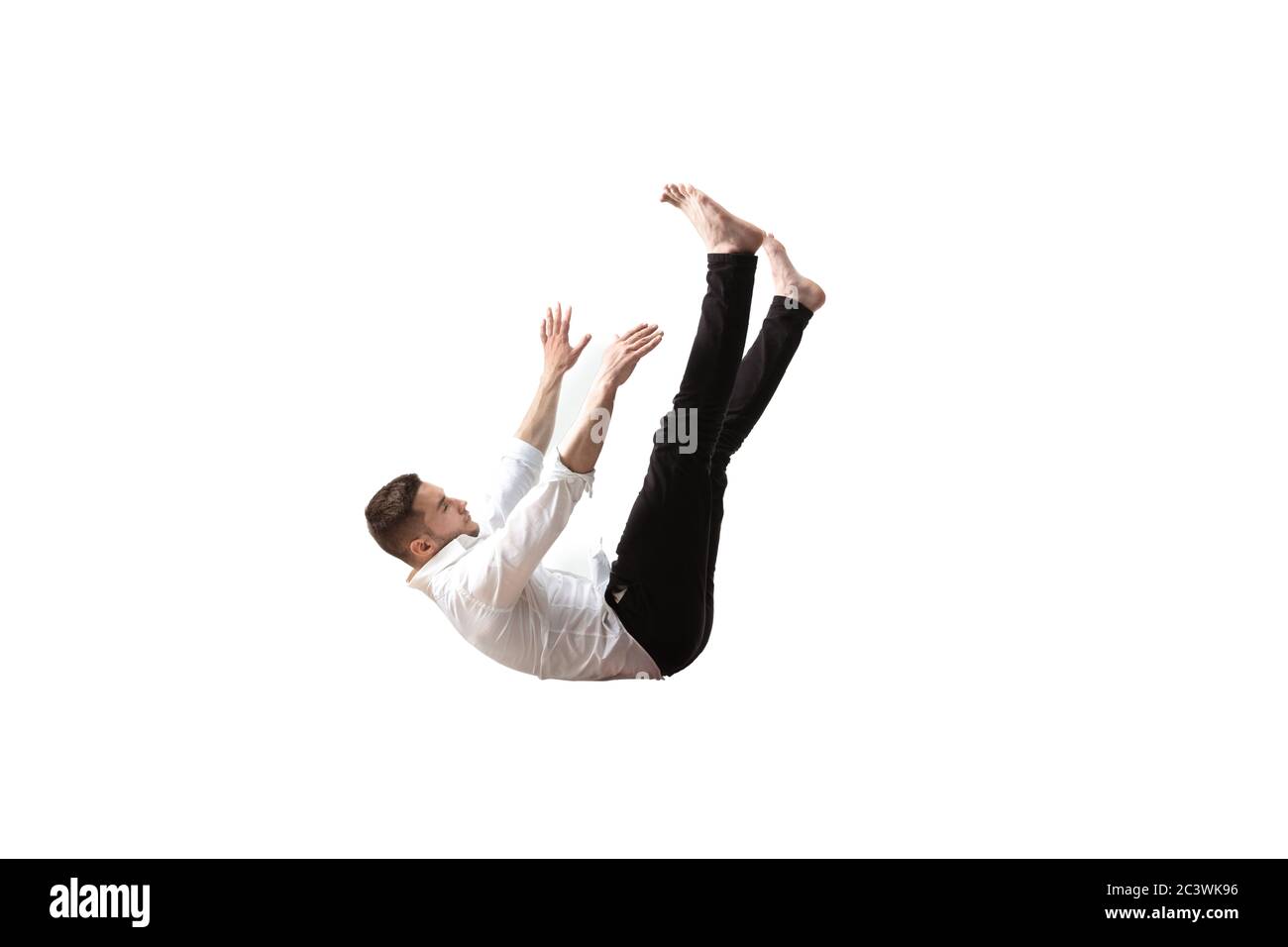 Mid-air beauty cought in moment. Full length shot of young man hovering ...