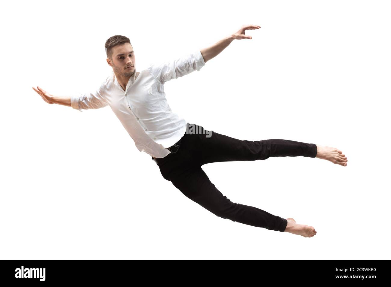 Mid-air beauty cought in moment. Full length shot of young man hovering ...