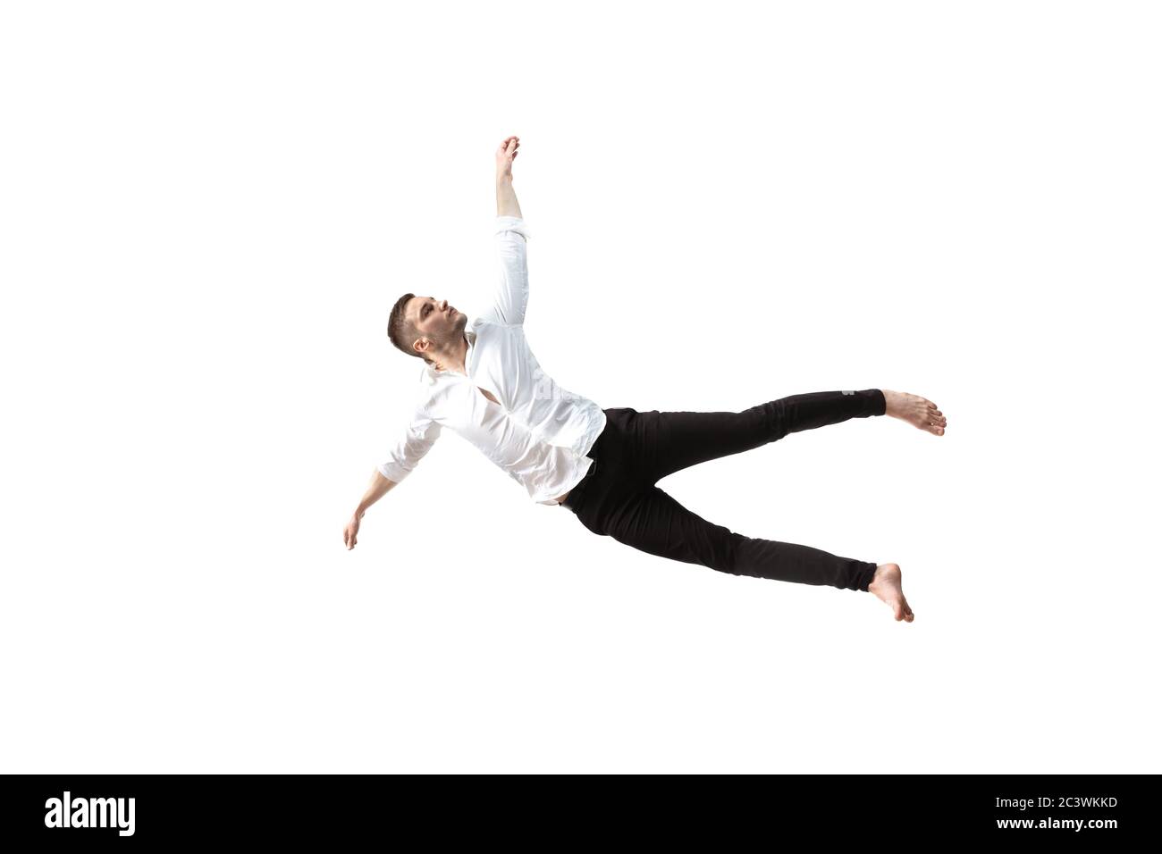 Mid-air beauty cought in moment. Full length shot of young man hovering ...