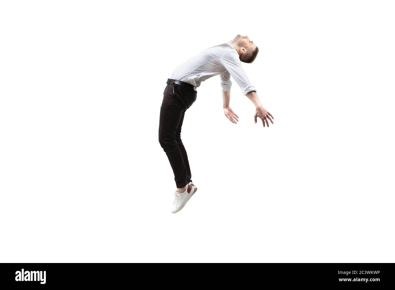 Mid-air beauty cought in moment. Full length shot of young man hovering ...