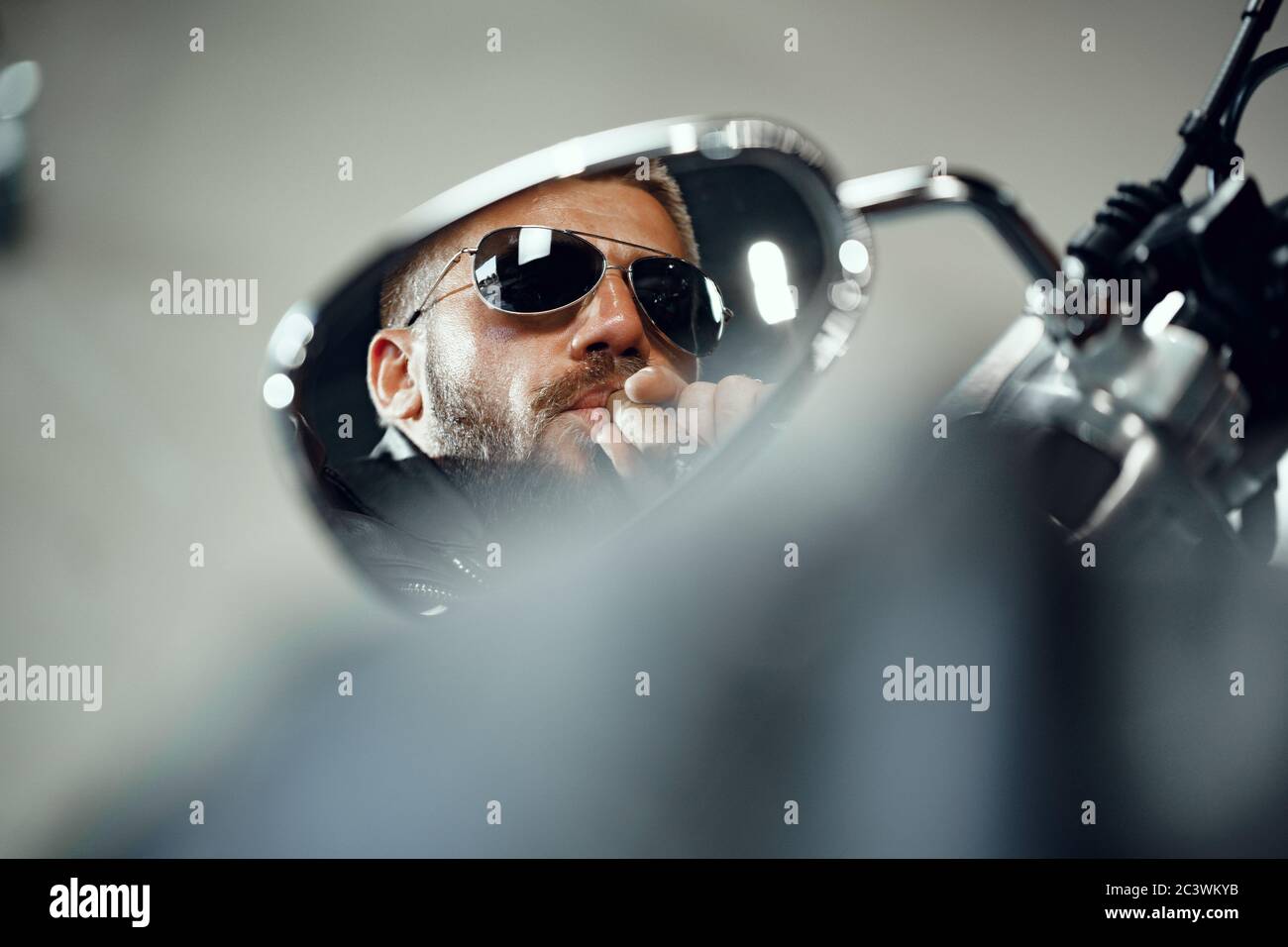 Reflection in the motorcycle mirror of a man driver in sunglasses Stock ...