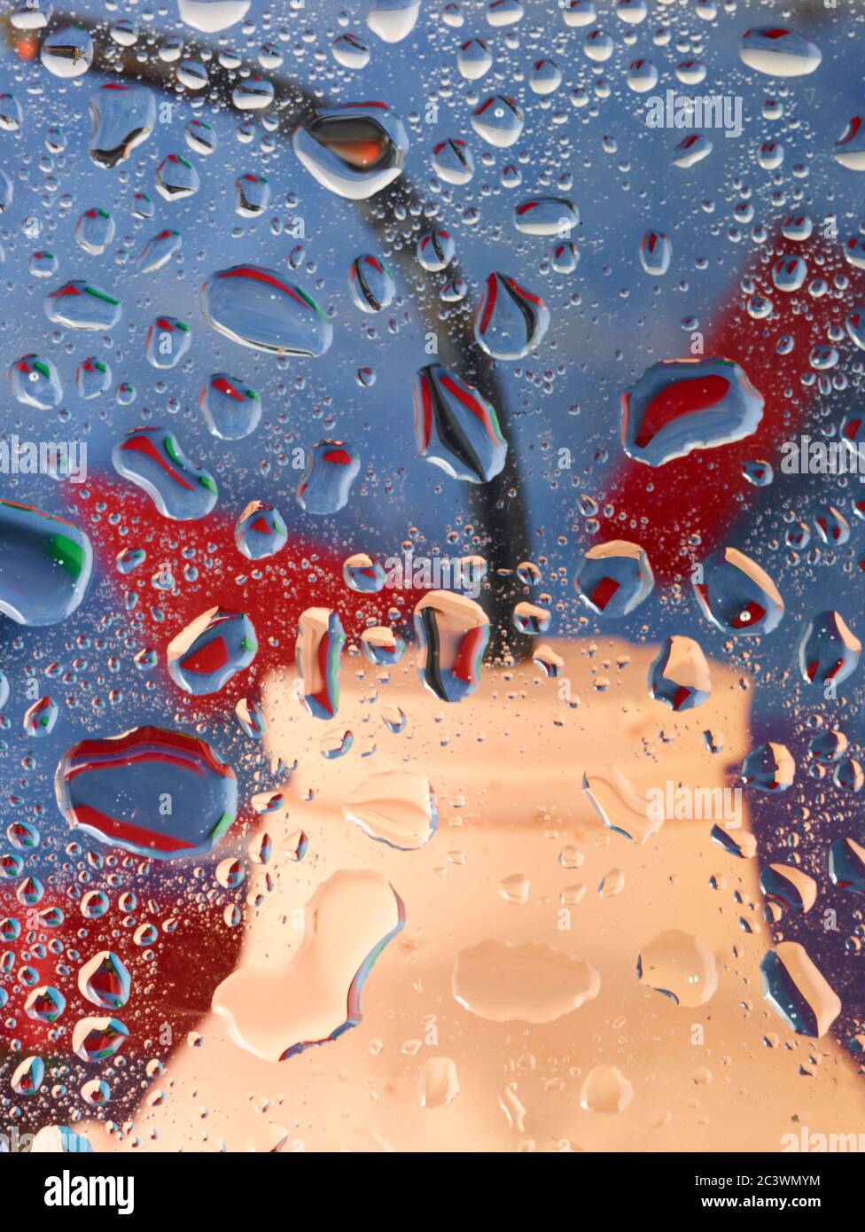 Colourful water drops, droplets, on a hard surface showing abstraction ...