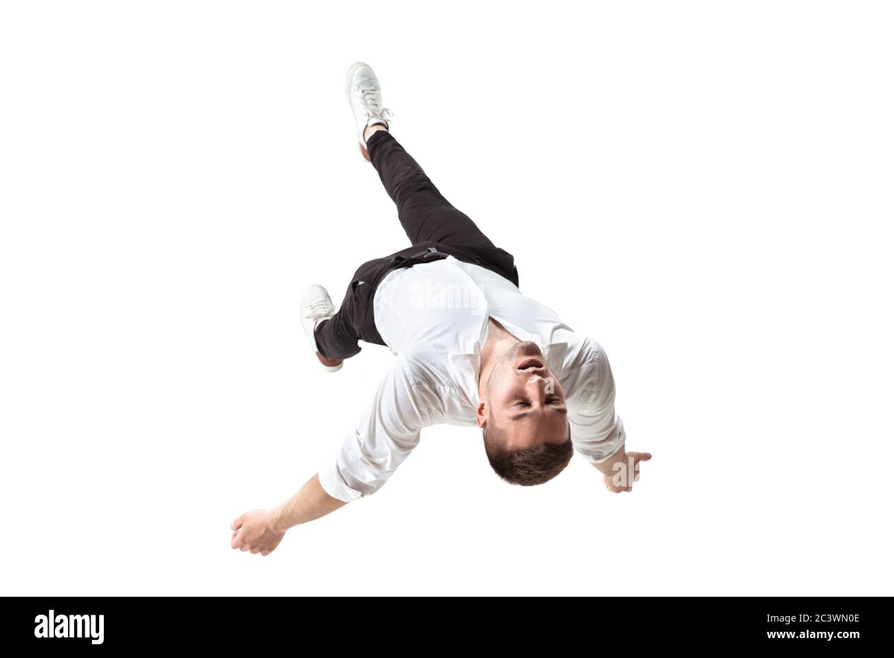 Mid-air beauty cought in moment. Full length shot of young man hovering ...