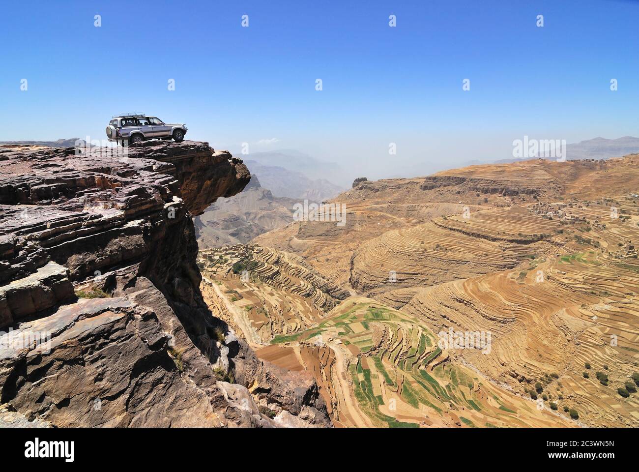 YEMEN – MARCH 13, 2010: Off-road vehicle on the edge of a steep cliff ...