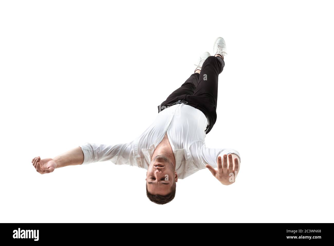 Mid-air beauty cought in moment. Full length shot of young man hovering ...
