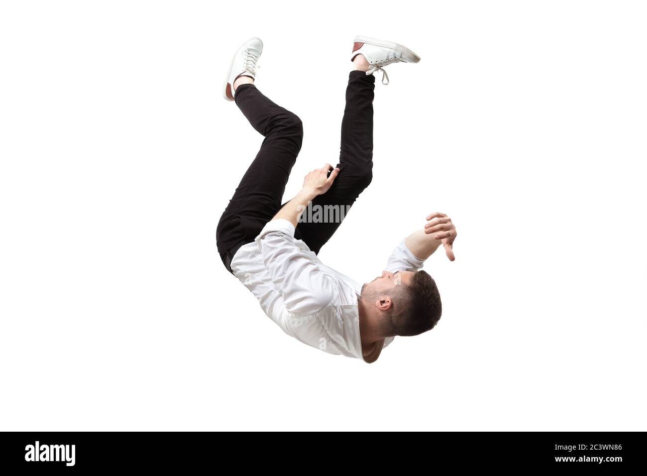 Mid-air beauty cought in moment. Full length shot of young man hovering ...