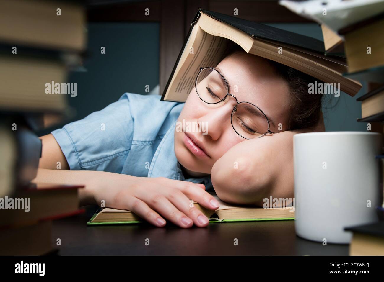 girl student who fell asleep while studying at home in the evening ...