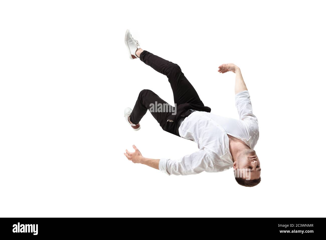 Mid-air beauty cought in moment. Full length shot of young man hovering ...