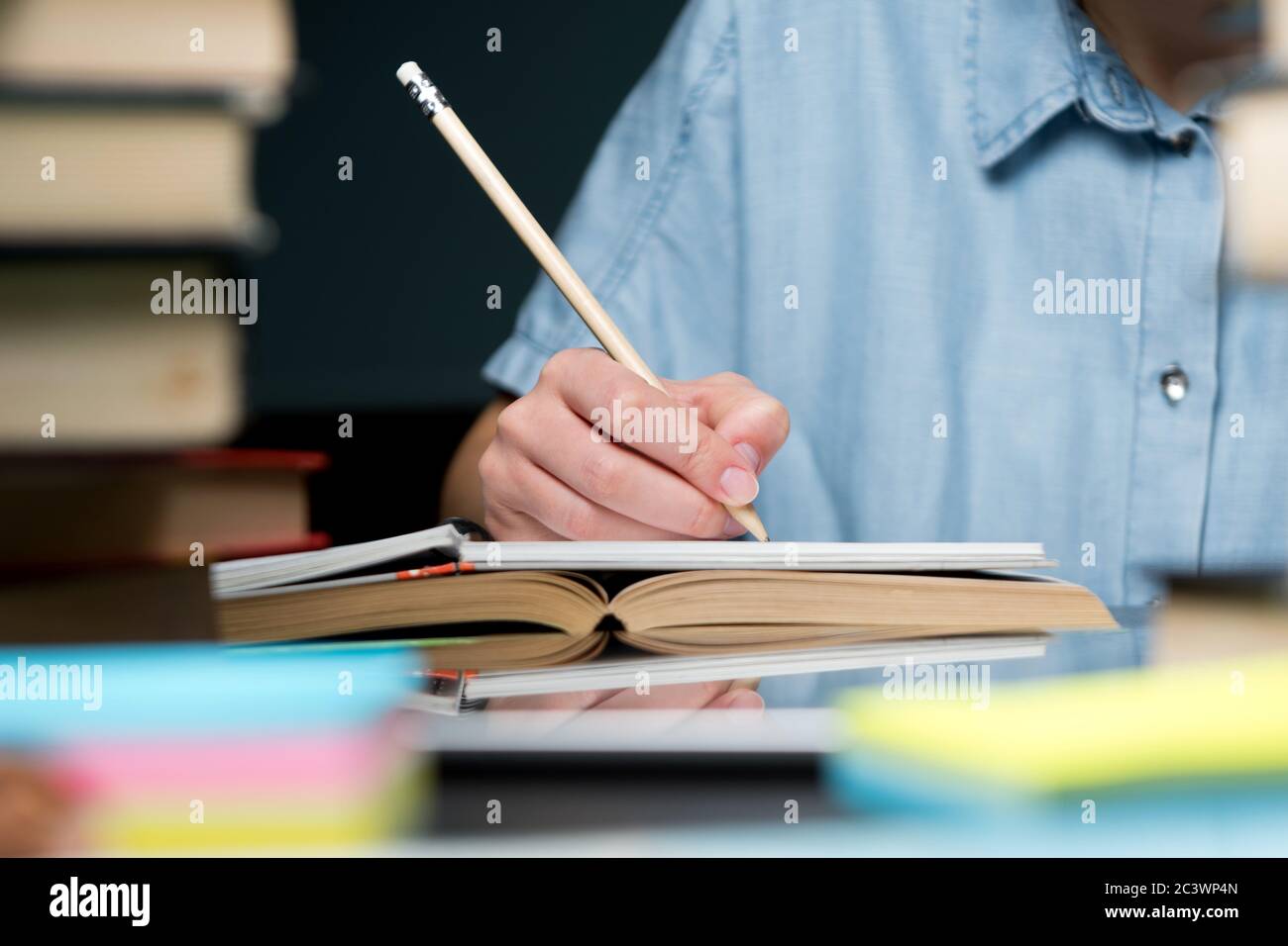 Pencil in the hand of a student. She takes notes in a notebook Stock ...