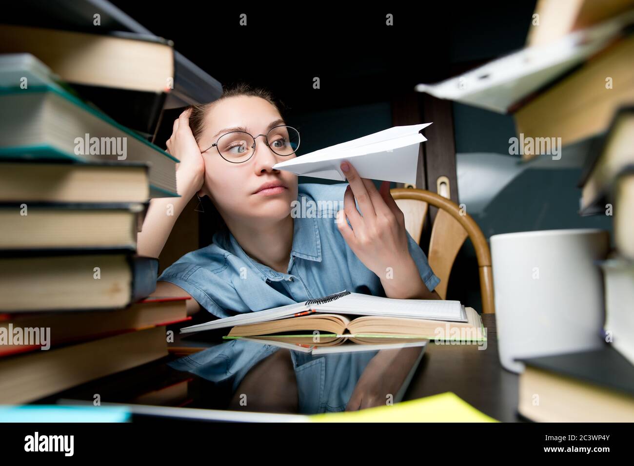 student is tired of studying and is playing the fool Stock Photo - Alamy