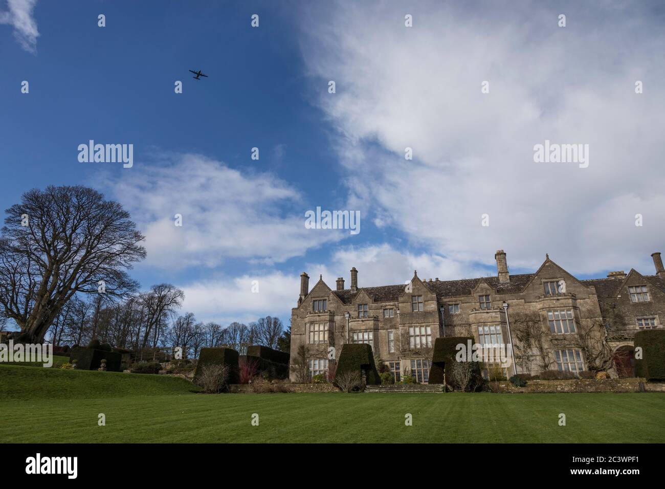 A large military plane flies over the house at Miserden estate ...