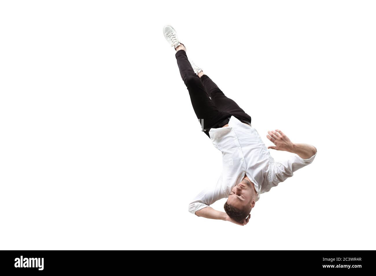 Mid-air beauty cought in moment. Full length shot of young man hovering ...