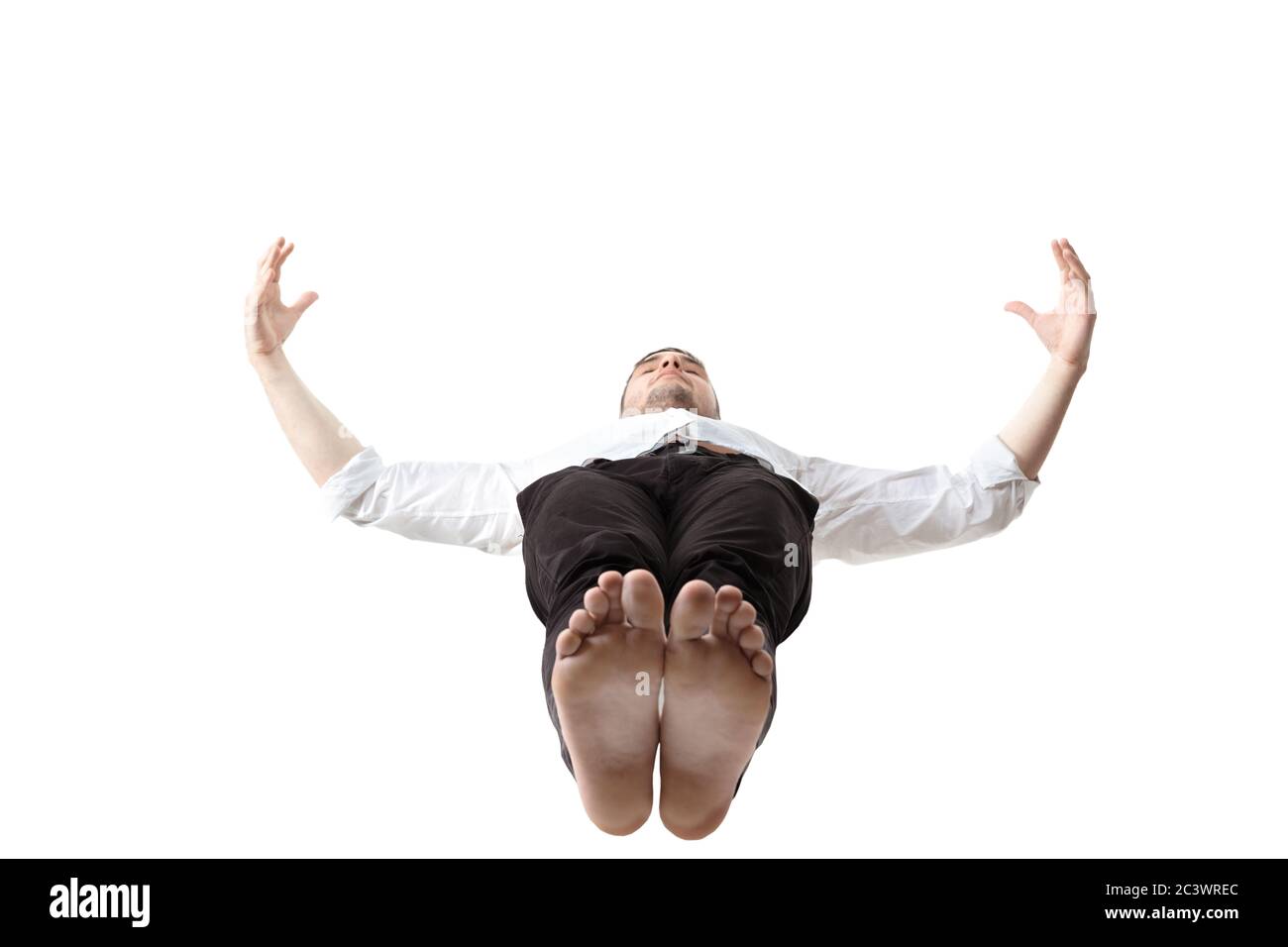 Mid-air beauty cought in moment. Full length shot of young man hovering ...