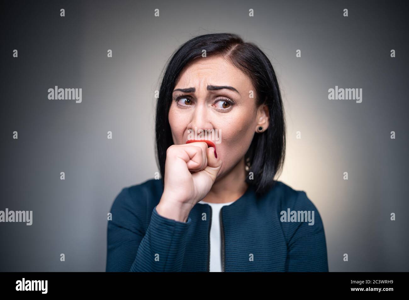 anxious brunette female worry and bite fingers Stock Photo - Alamy