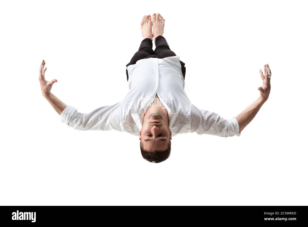 Mid-air beauty cought in moment. Full length shot of young man hovering ...