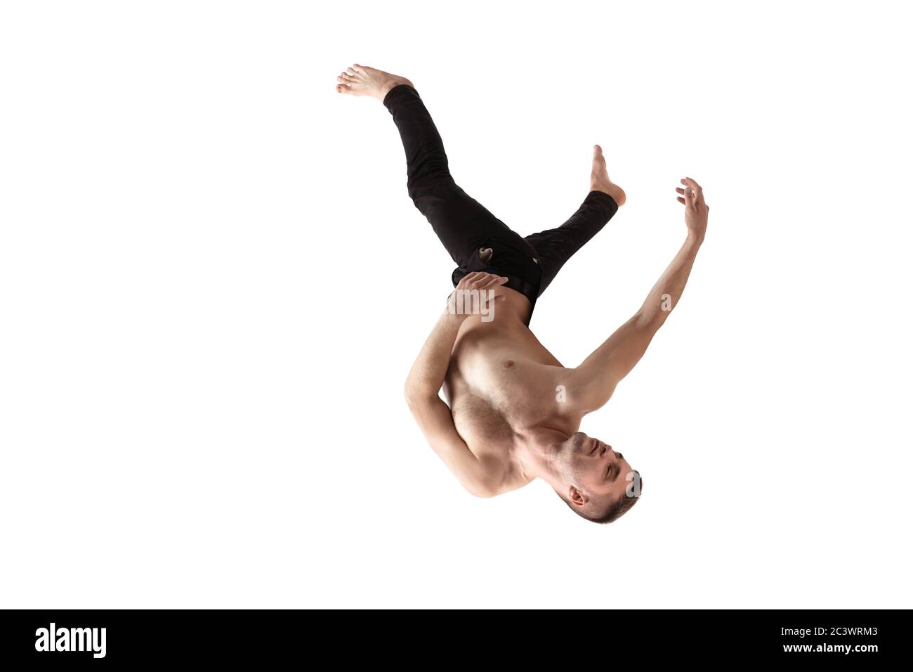 Mid-air beauty cought in moment. Full length shot of young man hovering ...