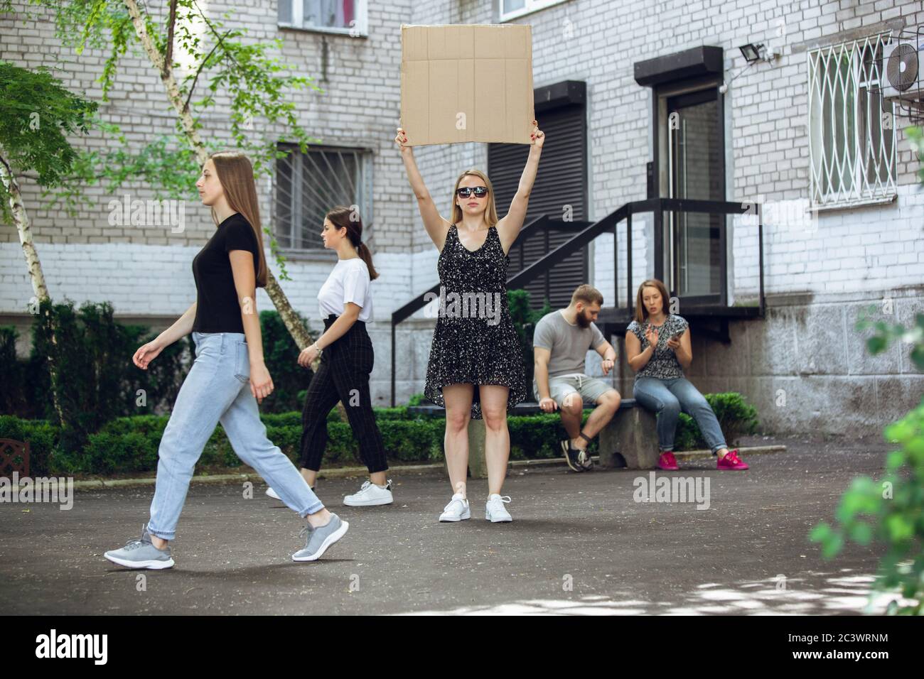 Dude with sign - woman stands protesting things that annoy her. Solo ...