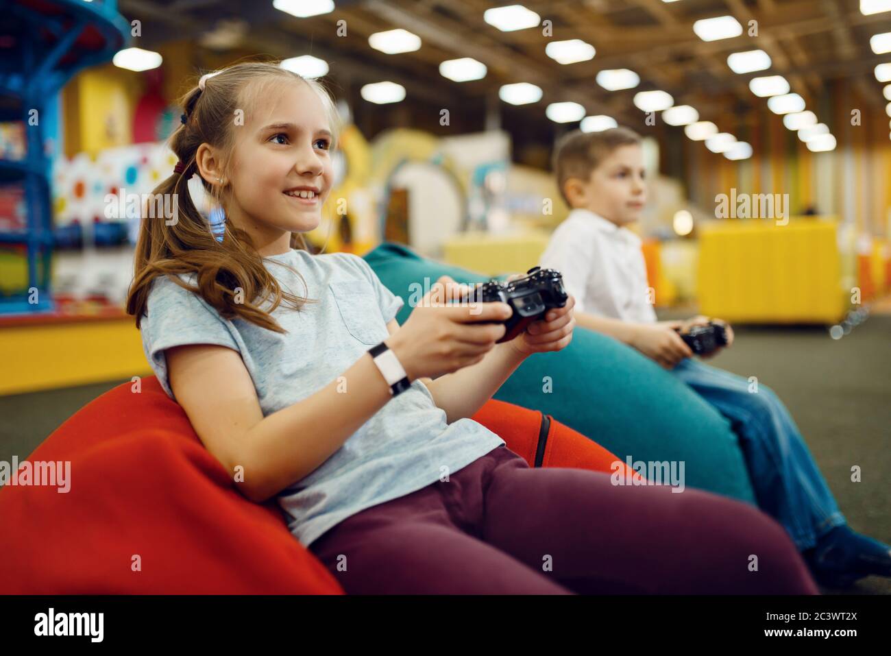 Children plays game console, entertainment center Stock Photo - Alamy